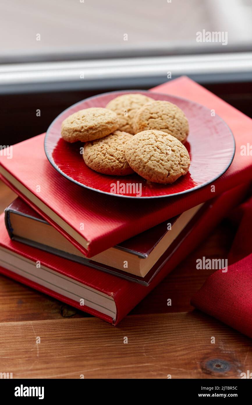 cookies on plate and books on window sill at home Stock Photo - Alamy