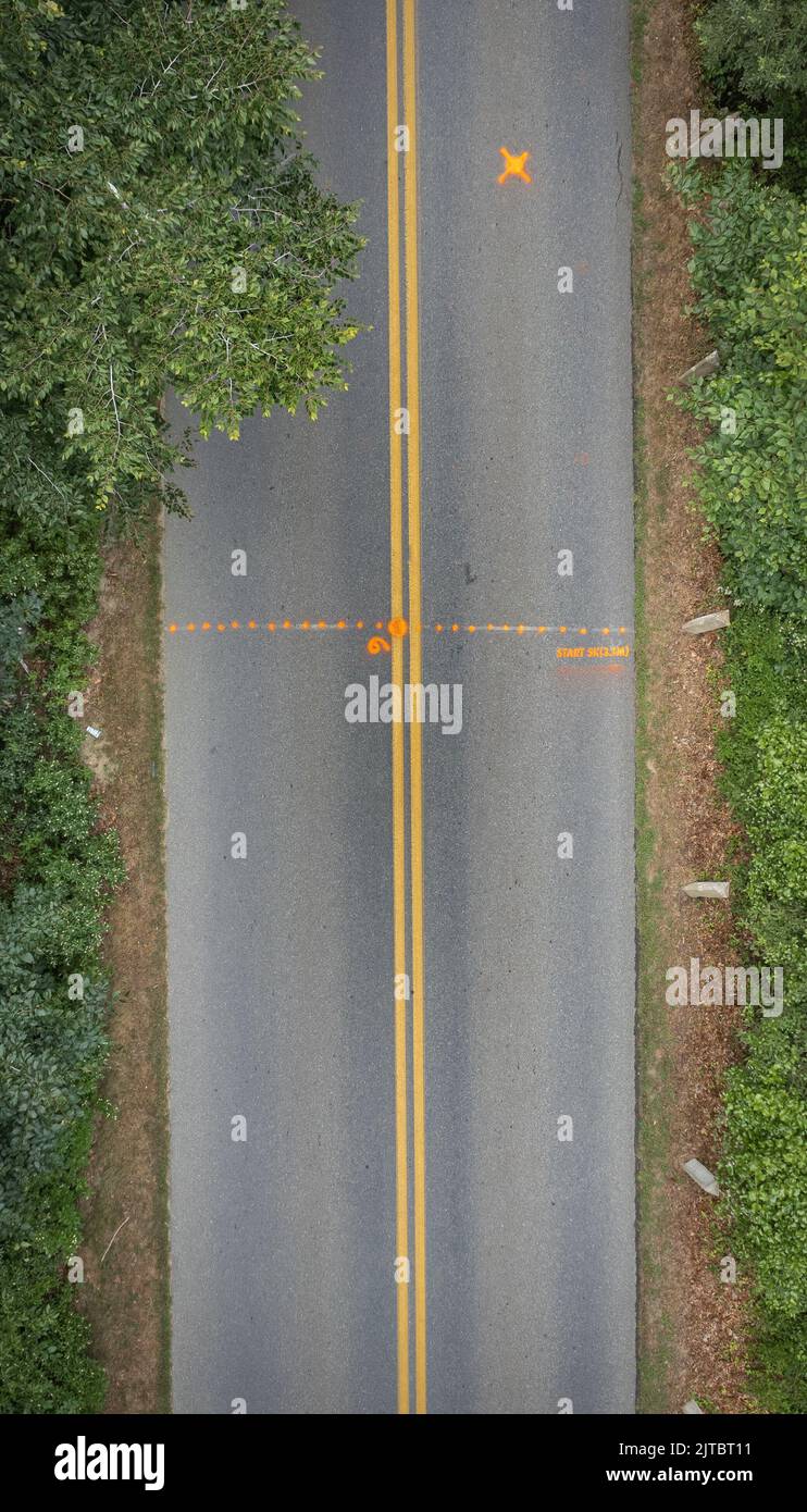 An aerial view of a roadway with spray painted markers ready for a road ...