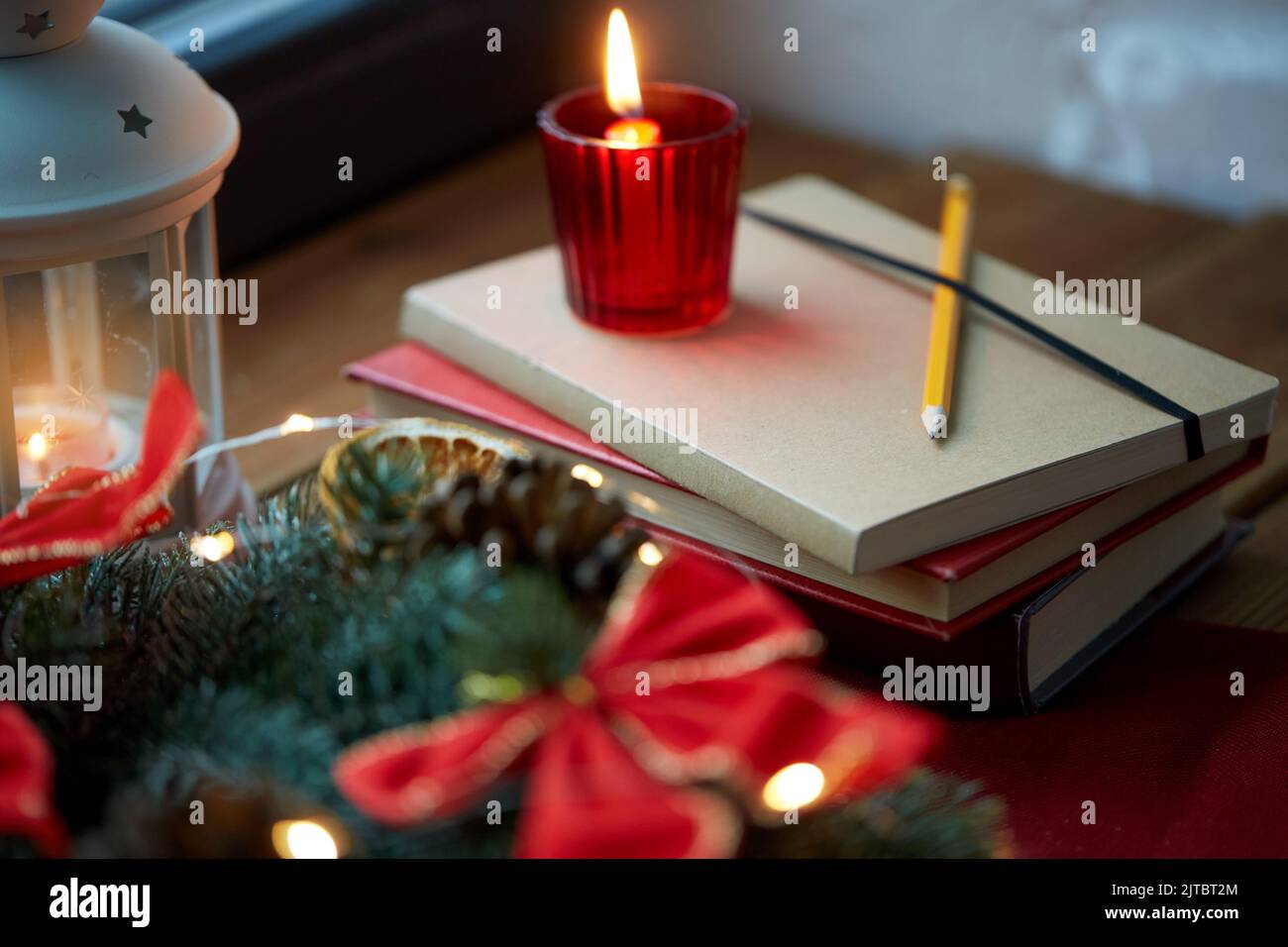 christmas wreath, books, candle, lantern on window Stock Photo - Alamy