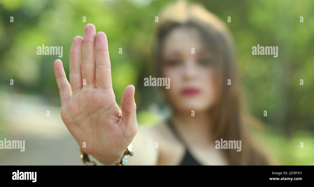 Latin woman disapproving with no hand sign waving finger gesture ...
