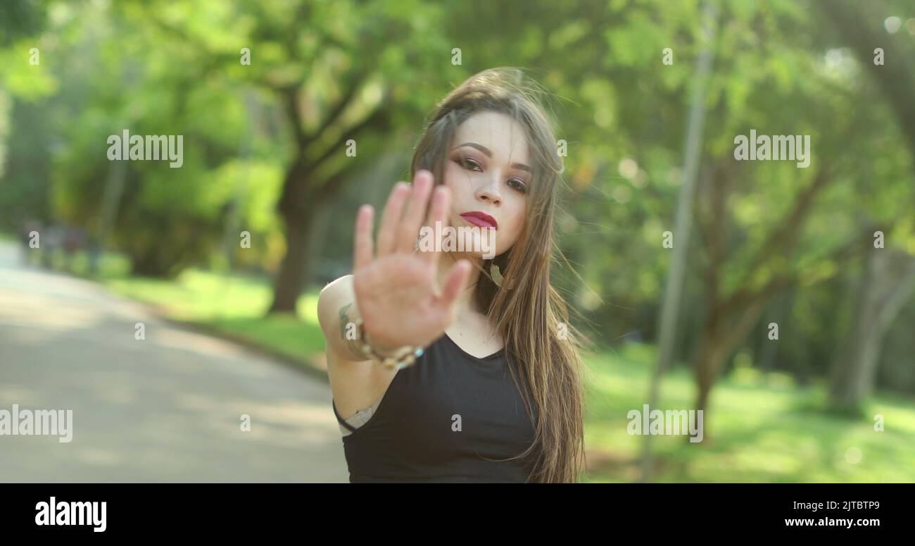 Latin woman disapproving with no hand sign waving finger gesture ...