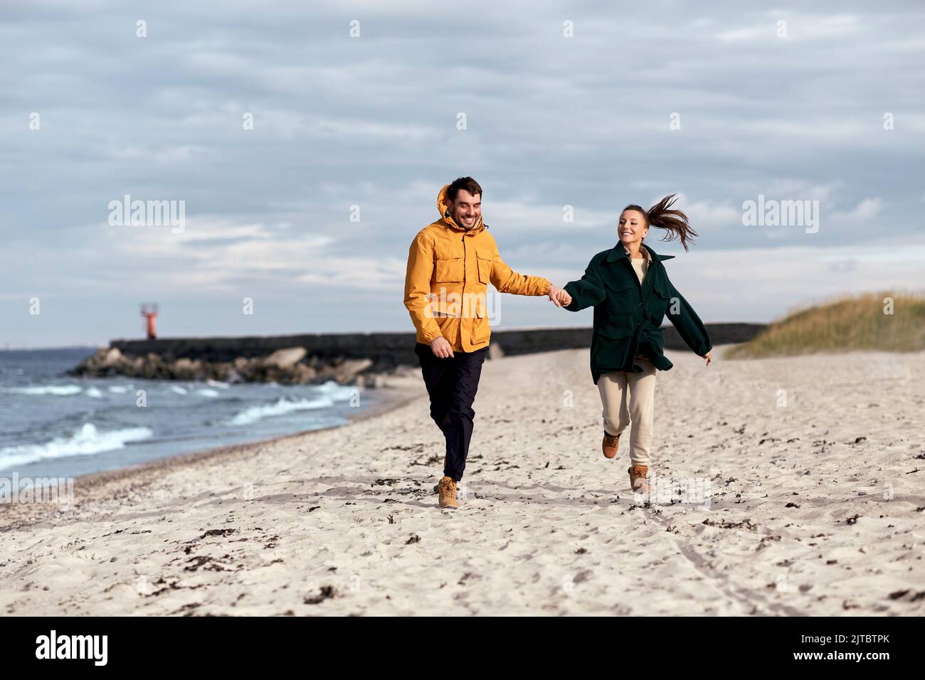Romantic couple running together hi-res stock photography and images ...