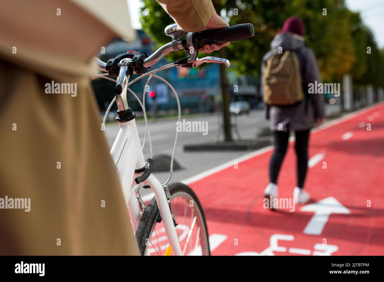 close up of cyclist behind pedestrian on bike lane Stock Photo - Alamy