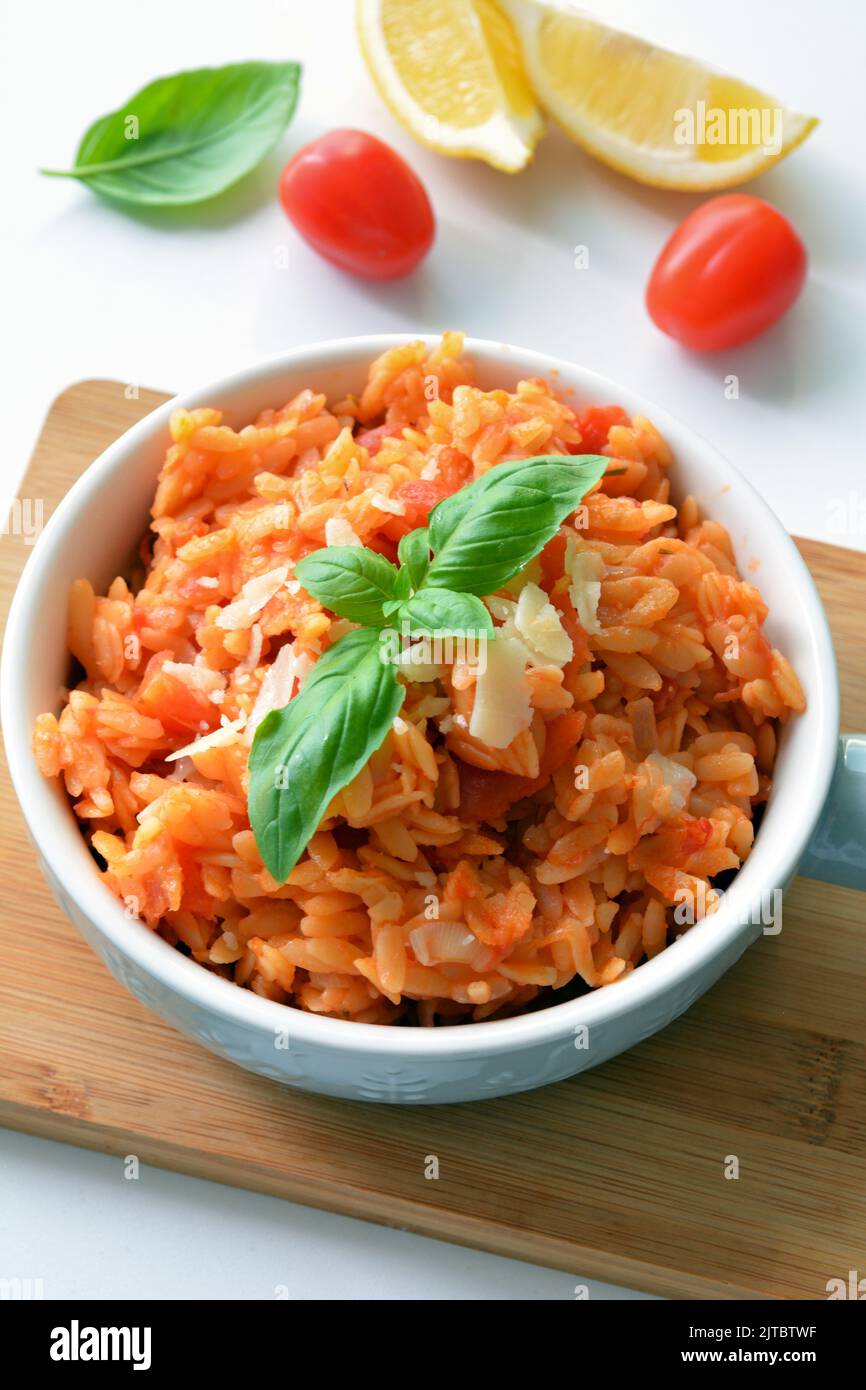 Kritharaki with tomatoes and chicken. Traditional type of Greek pasta ...