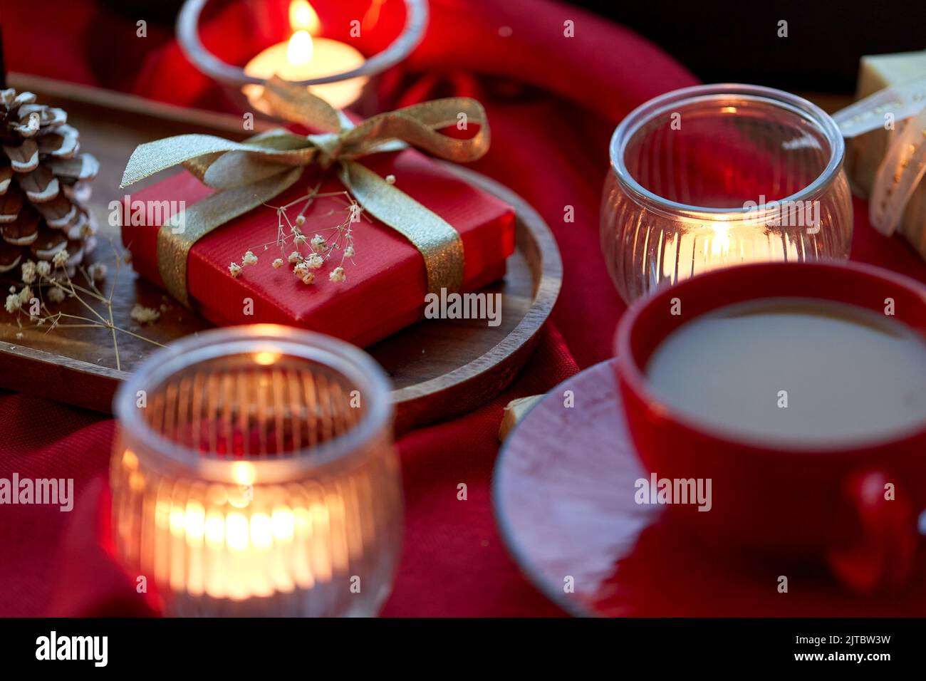 christmas gift, candles and coffee on window sill Stock Photo - Alamy