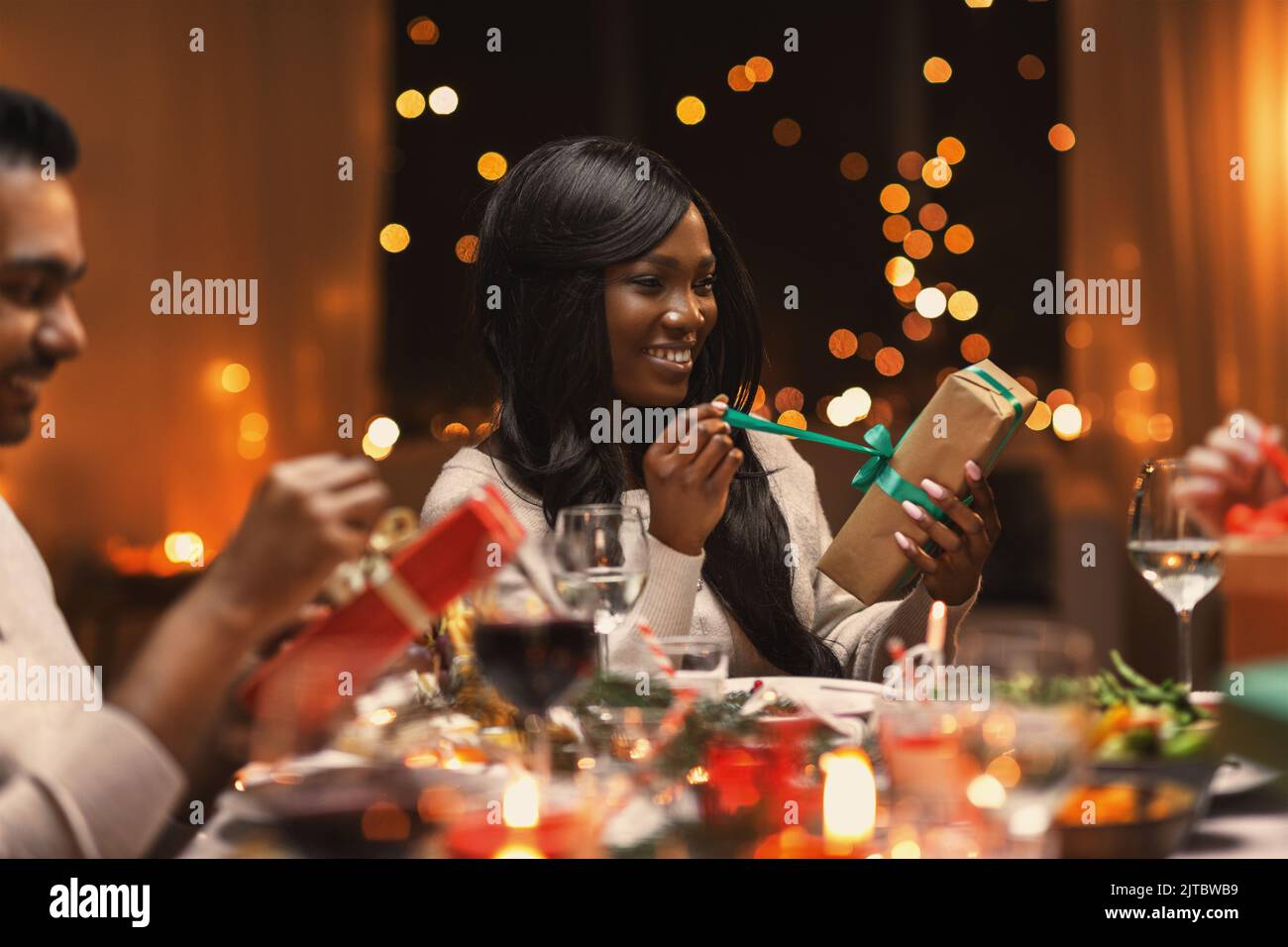 happy friends giving christmas presents at home Stock Photo - Alamy