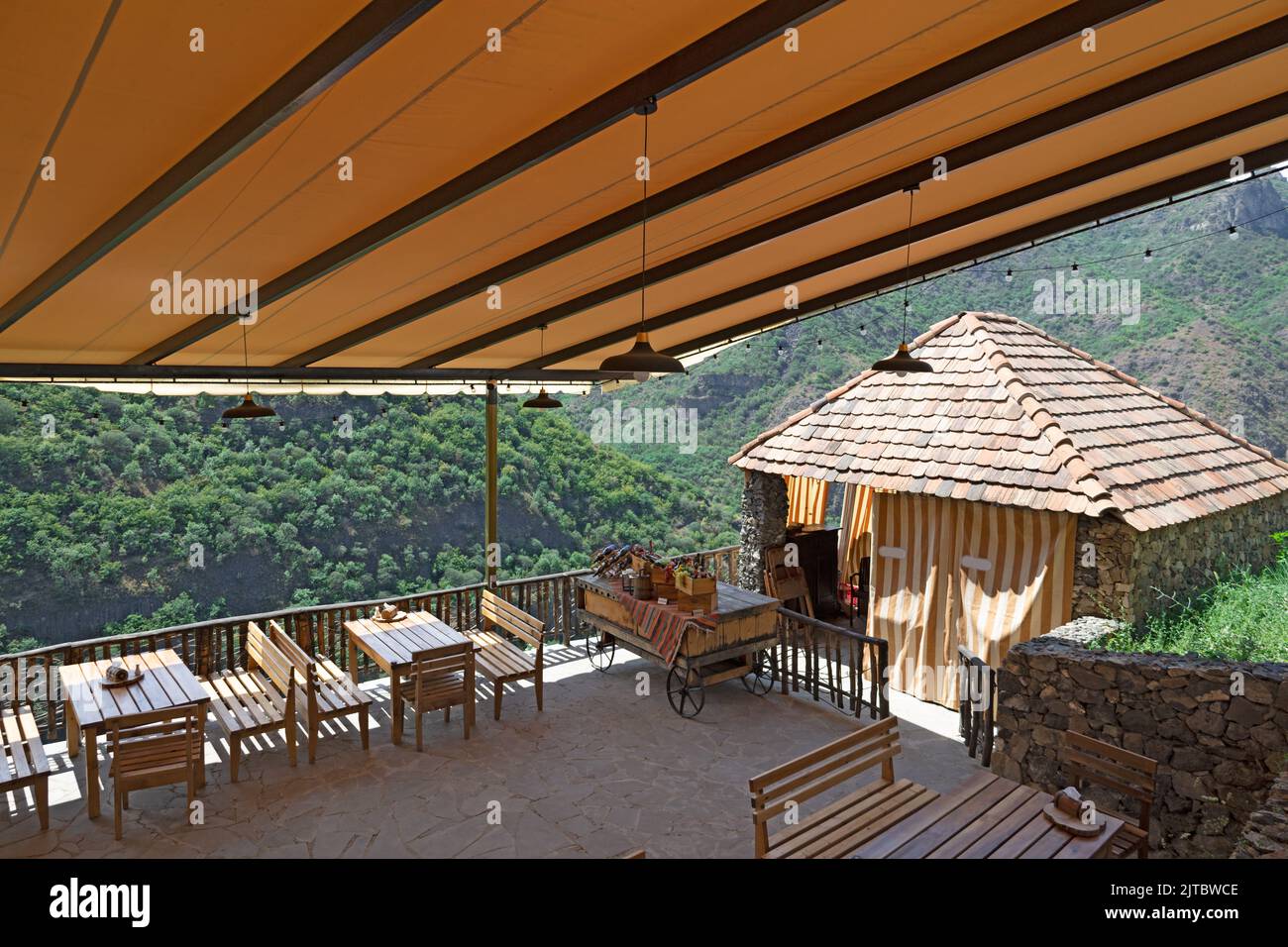 Wooden tables and chairs made in an open air restaurant ready to ...