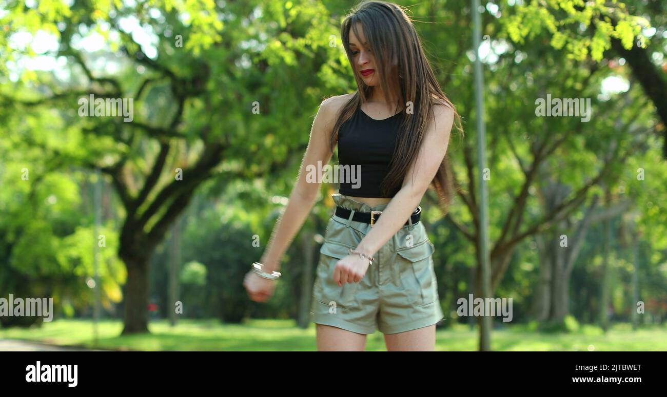 Millennial girl dancing floss dance in outdoor park Stock Photo - Alamy