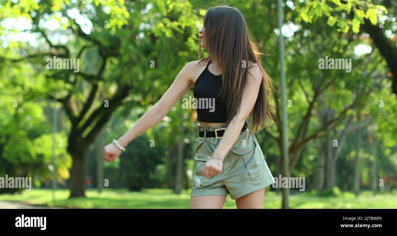 Millennial girl dancing floss dance in outdoor park Stock Photo - Alamy