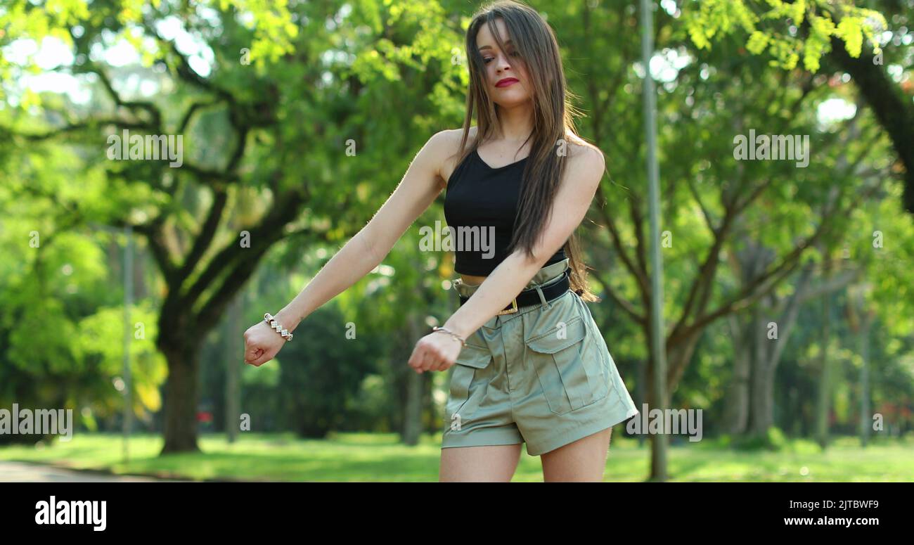 Millennial girl dancing floss dance in outdoor park Stock Photo - Alamy