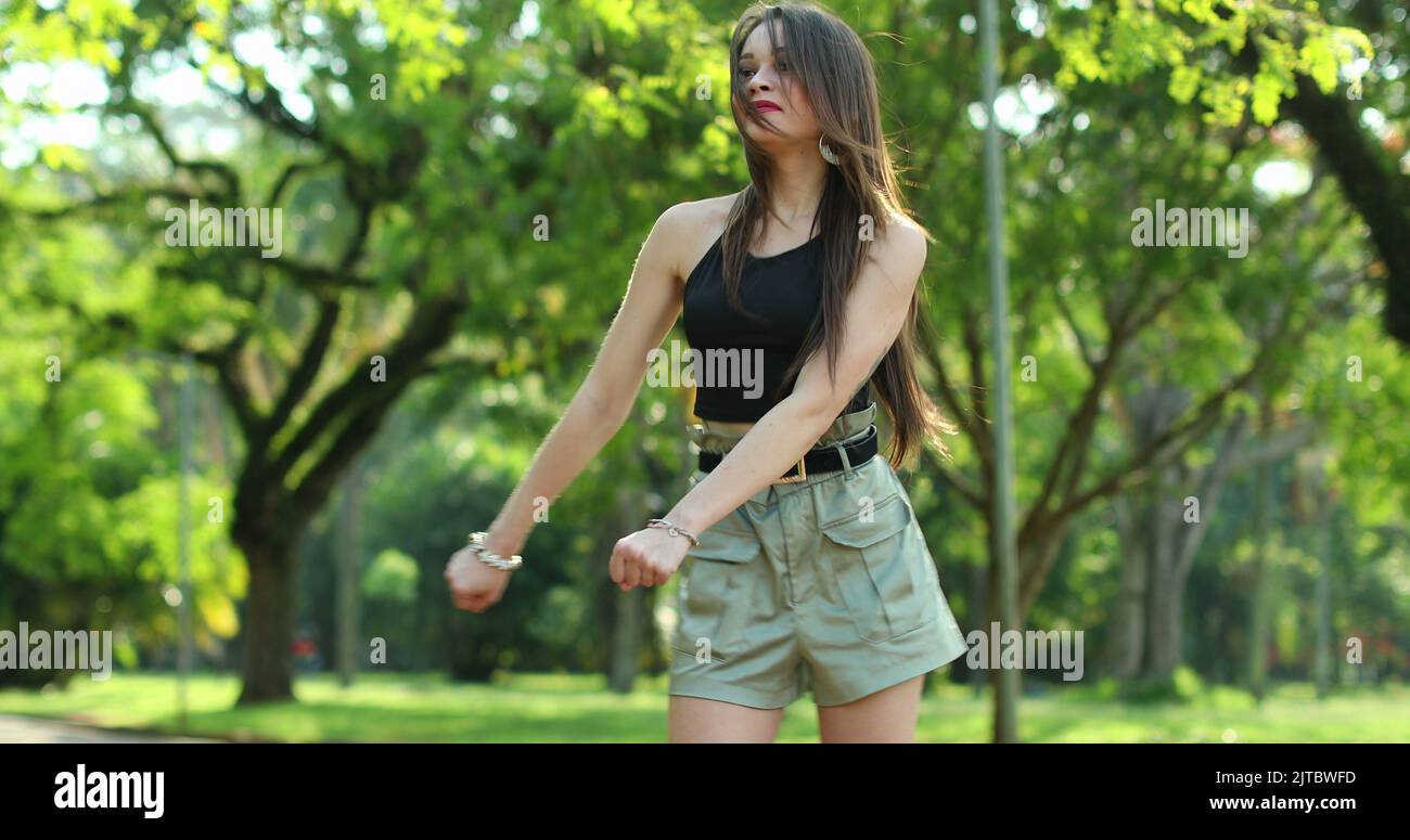 Millennial girl dancing floss dance in outdoor park Stock Photo - Alamy