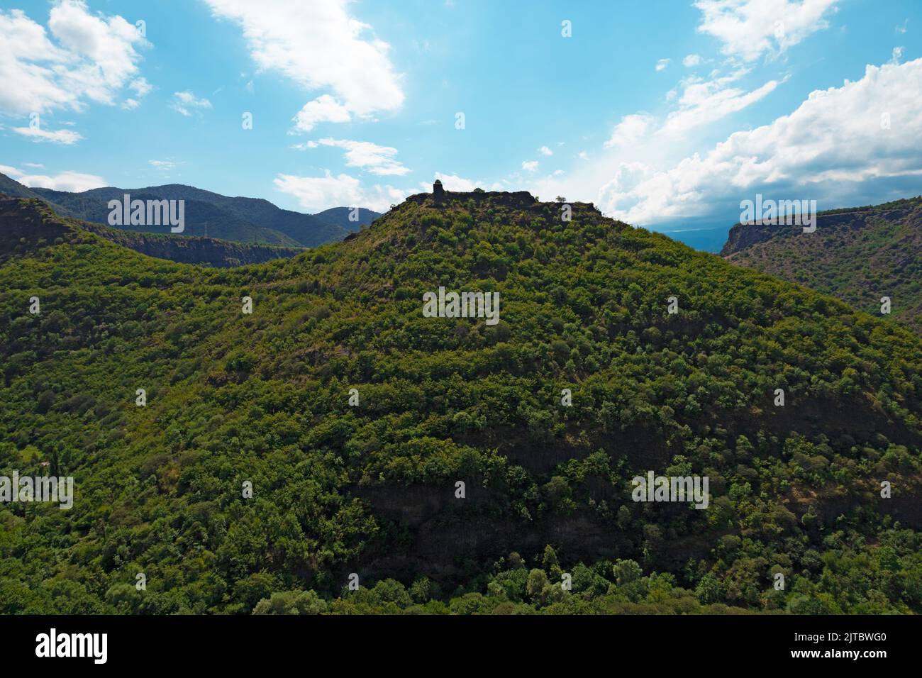 Medieval Kayan fortress on top of a hill, surrounded by forest and high ...