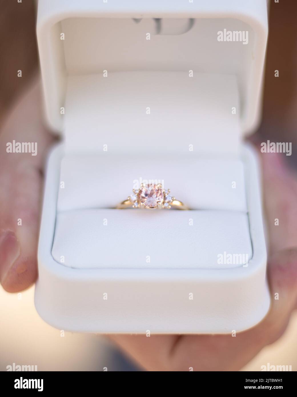 A beautiful ring with bright crystal in a white box, ring is ready for ...