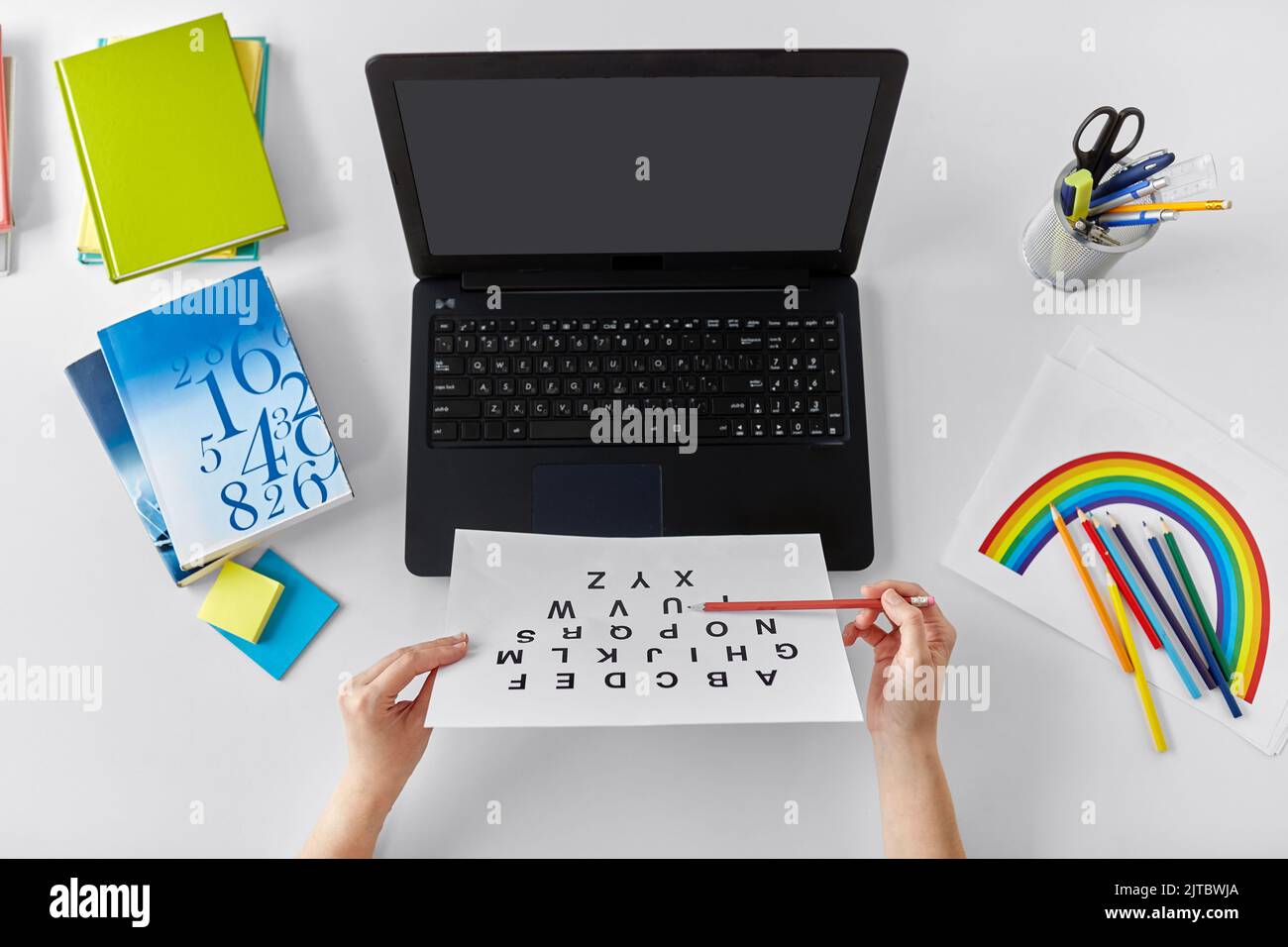 teacher with alphabet having online class at home Stock Photo - Alamy
