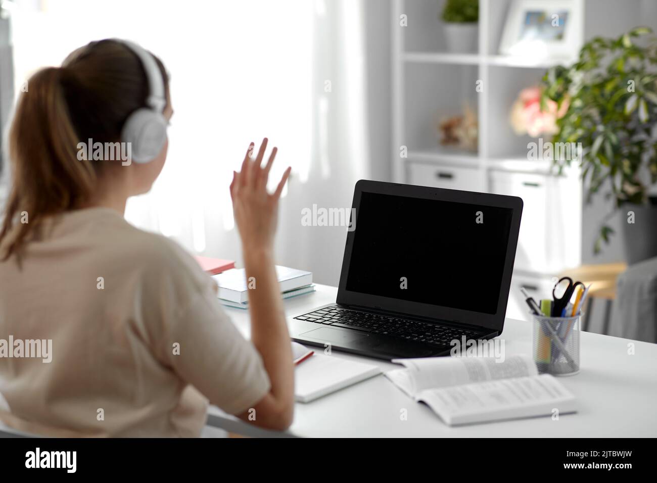 student with laptop having video call at home Stock Photo - Alamy