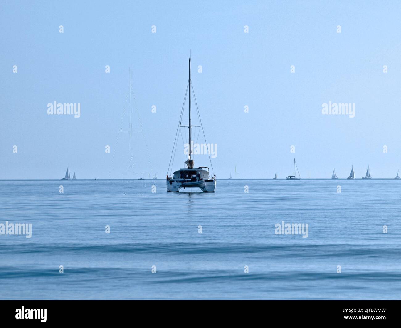 A sailboat floating on grand traverse bay Stock Photo - Alamy