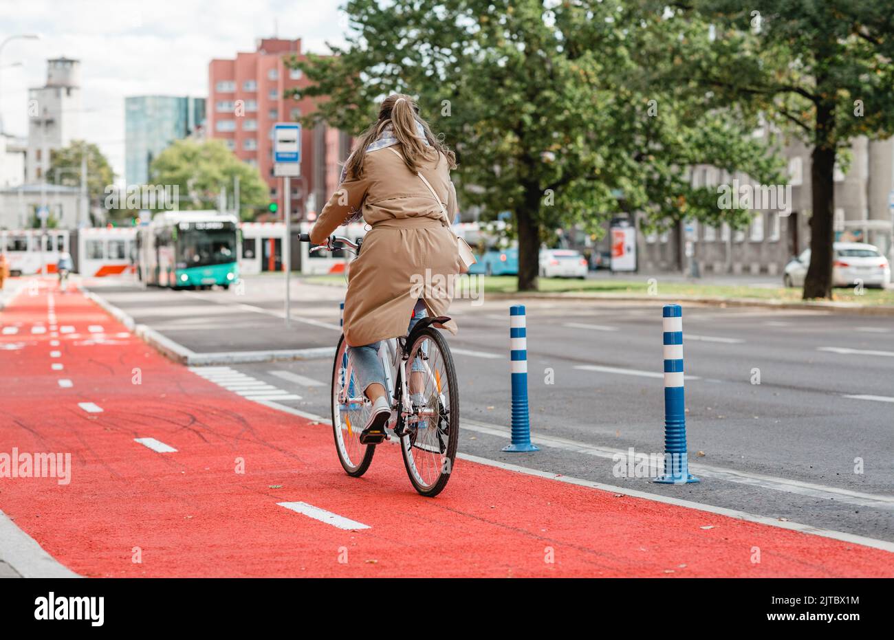 Back view of woman riding bicycle hi-res stock photography and images ...