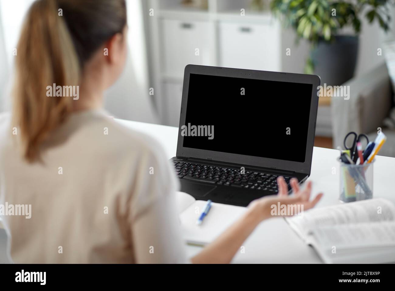 student with laptop having video call at home Stock Photo - Alamy