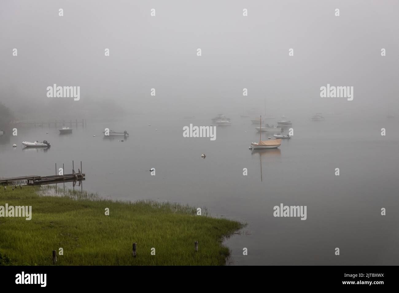 The foggy view of the lakeshore and boats in the fog Stock Photo - Alamy