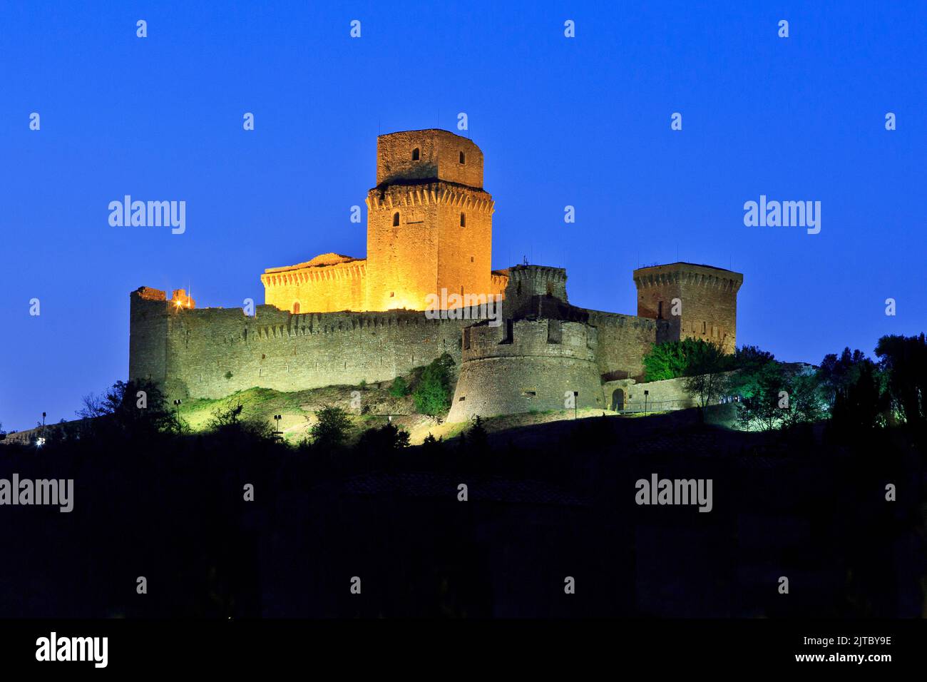 The hillside Rocca Maggiore Castle (1316) at dusk in Assisi (province ...