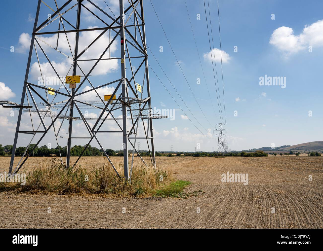 close-up of electricity power pylon and cables against a bright blue ...