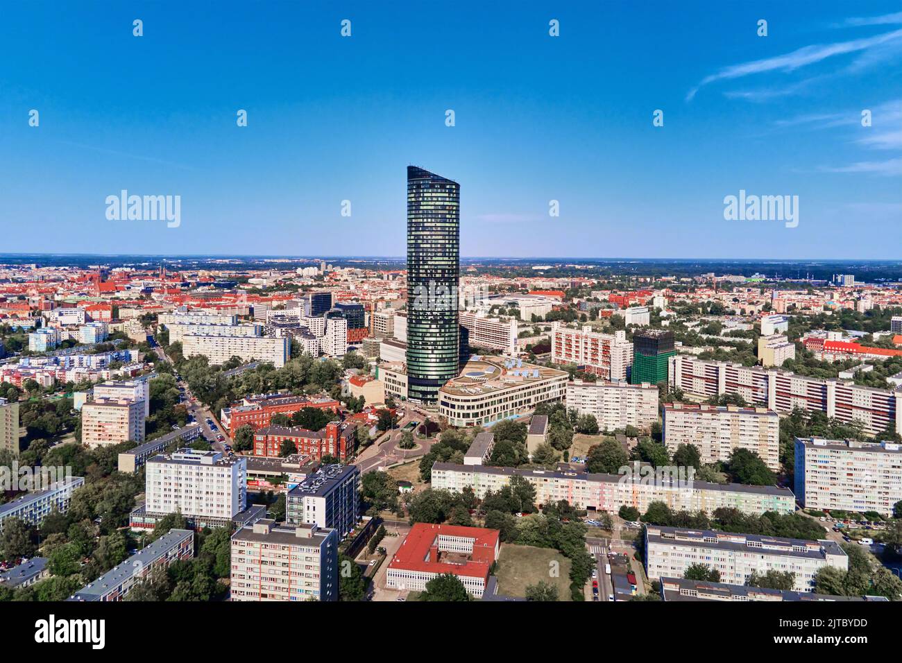 Drone flight over Wroclaw cityscape with Sky Tower skyscraper. Aerial view of modern european ...