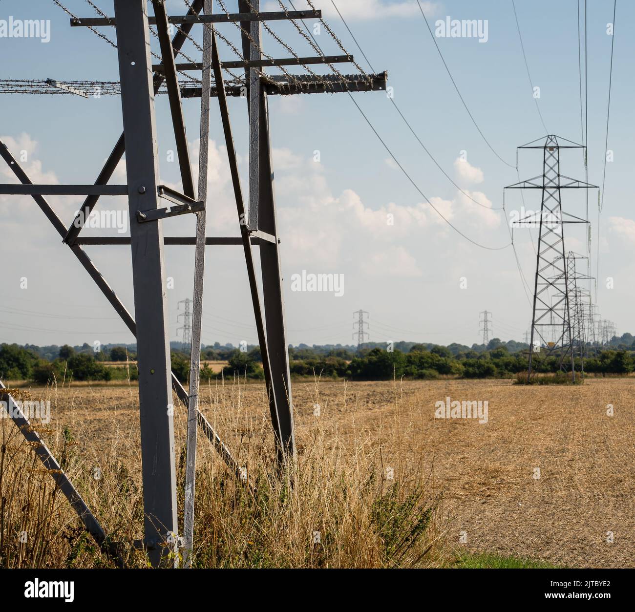 close-up of electricity power pylons and cables against a bright blue ...