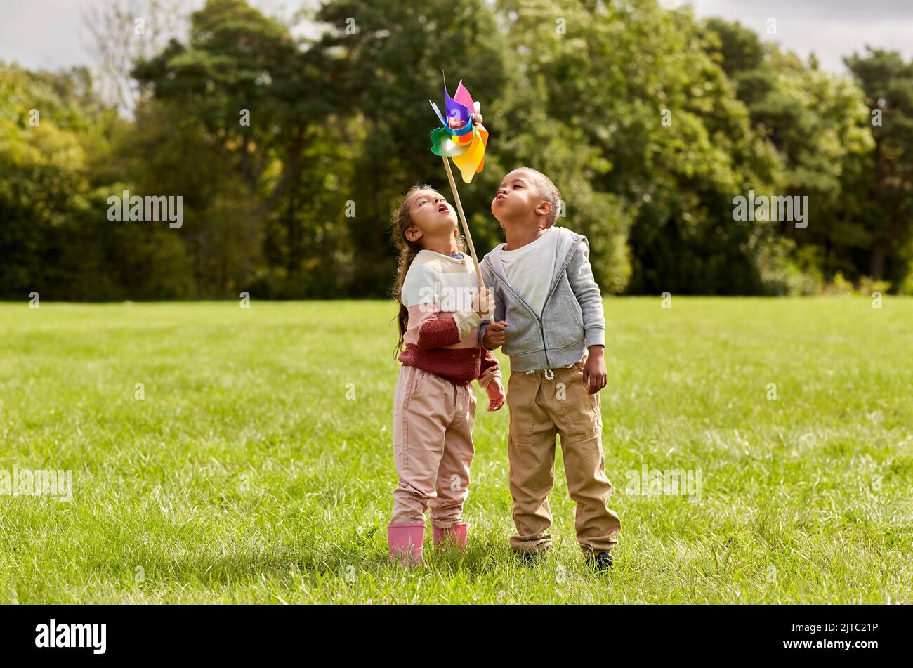 happy kids with pinwheel having fun at park Stock Photo - Alamy