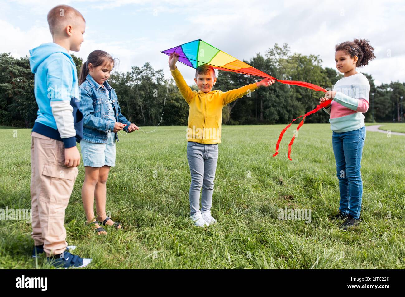 happy kids with kite playing at park Stock Photo - Alamy