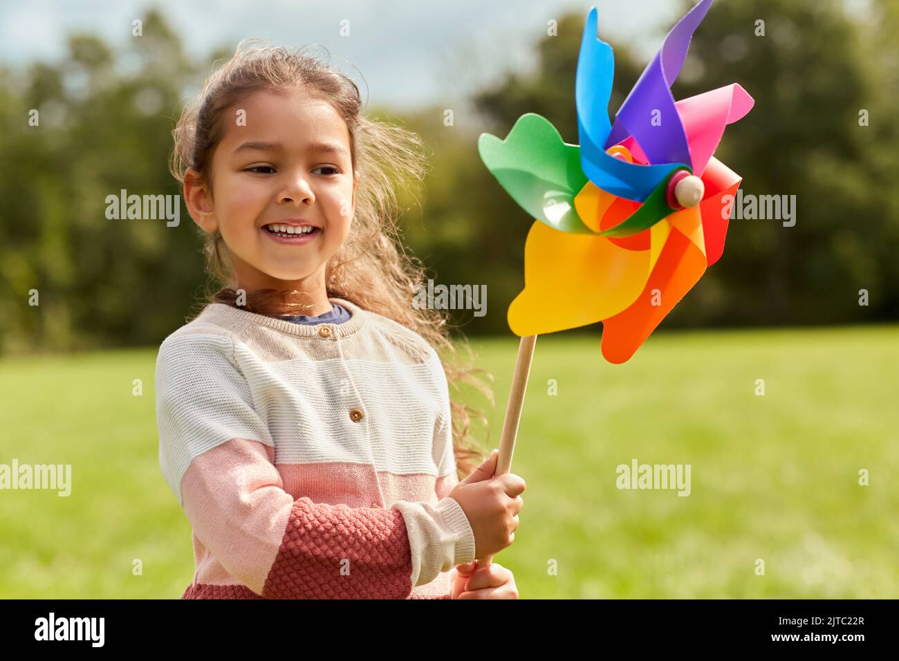 happy little girl with pinwheel playing at park Stock Photo - Alamy