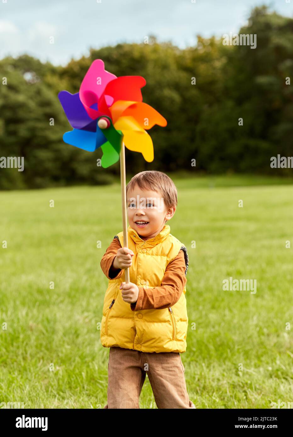 happy little boy with pinwheel playing at park Stock Photo - Alamy