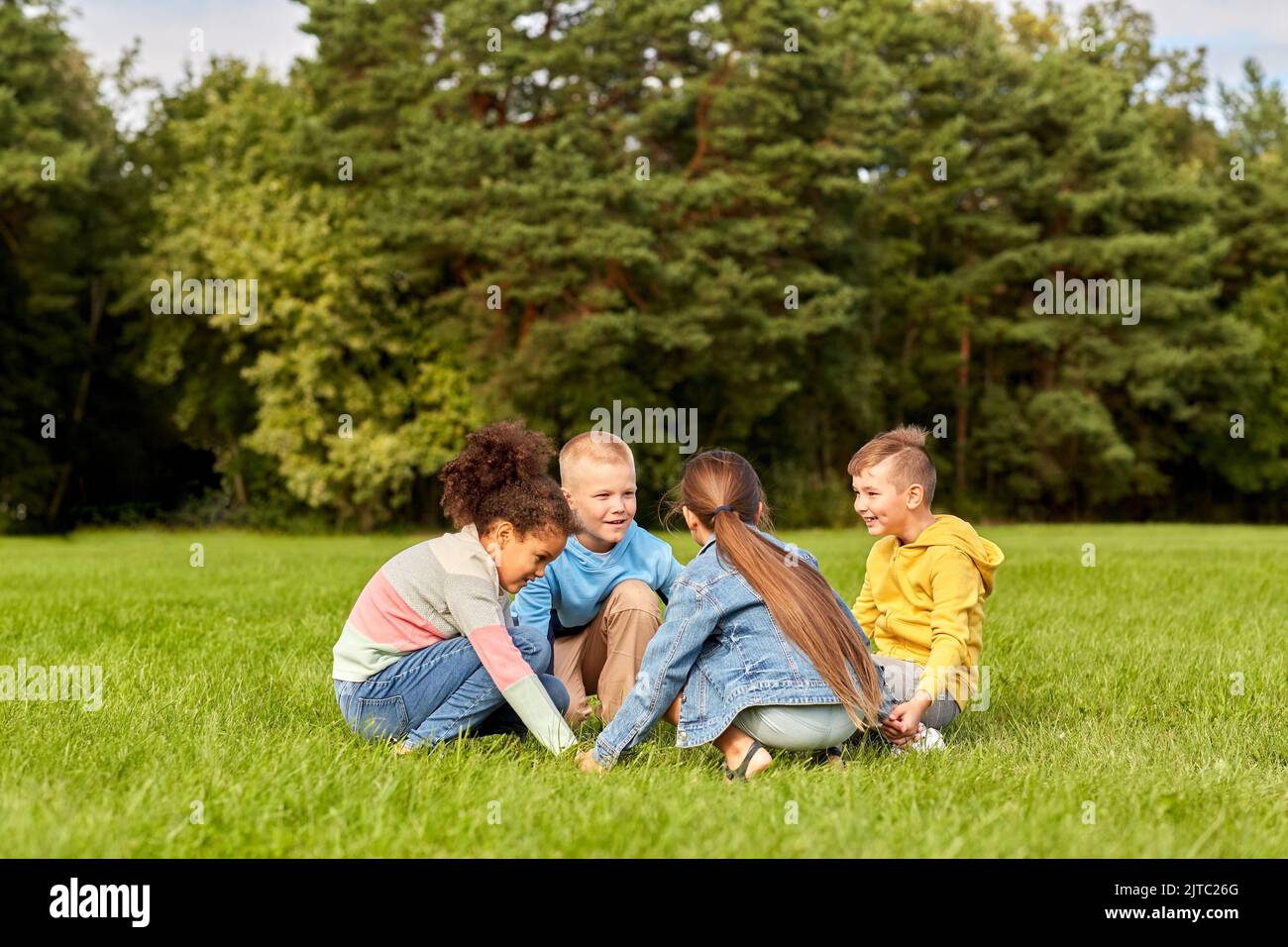 happy children playing round dance at park Stock Photo - Alamy