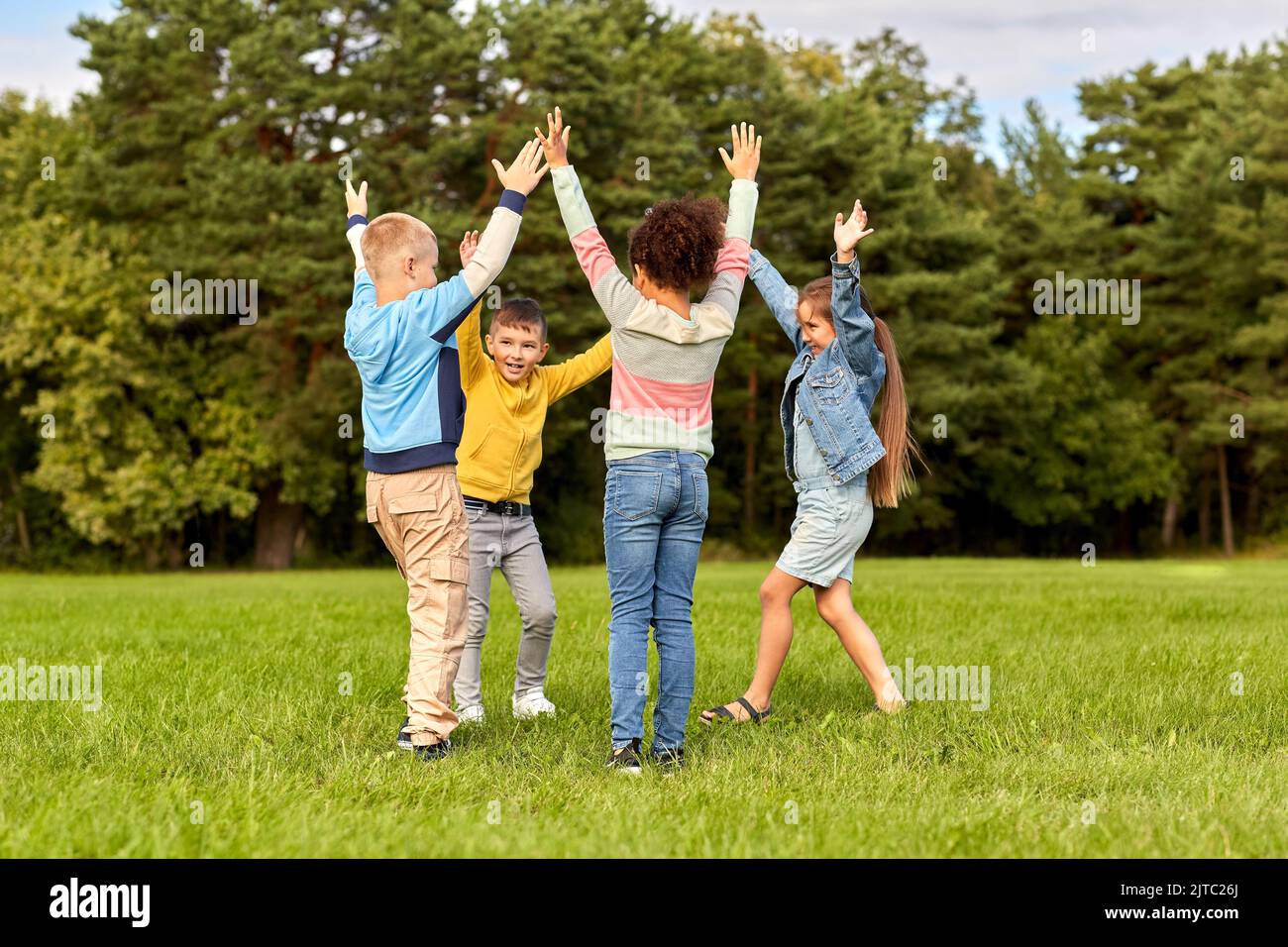 happy children playing round dance at park Stock Photo - Alamy