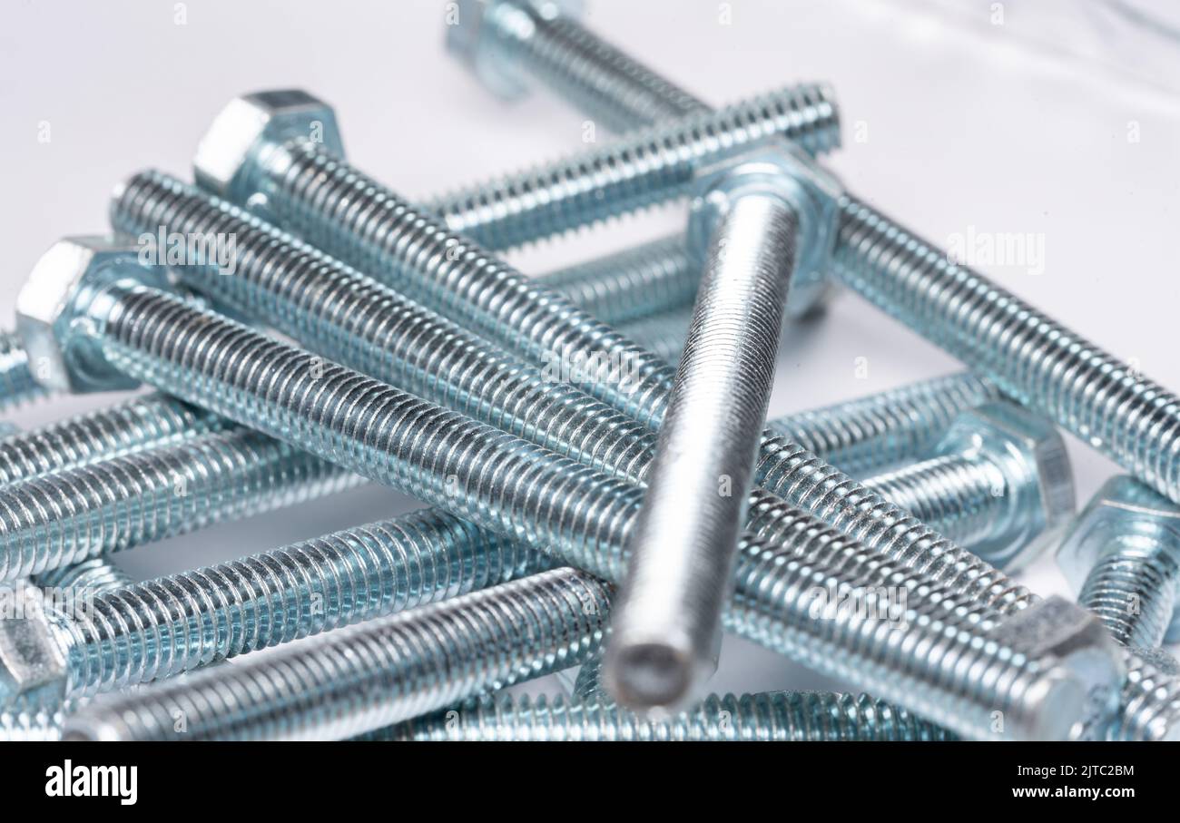 Screws in close-up. Metal long threaded bolts. Metal items. Metal ...