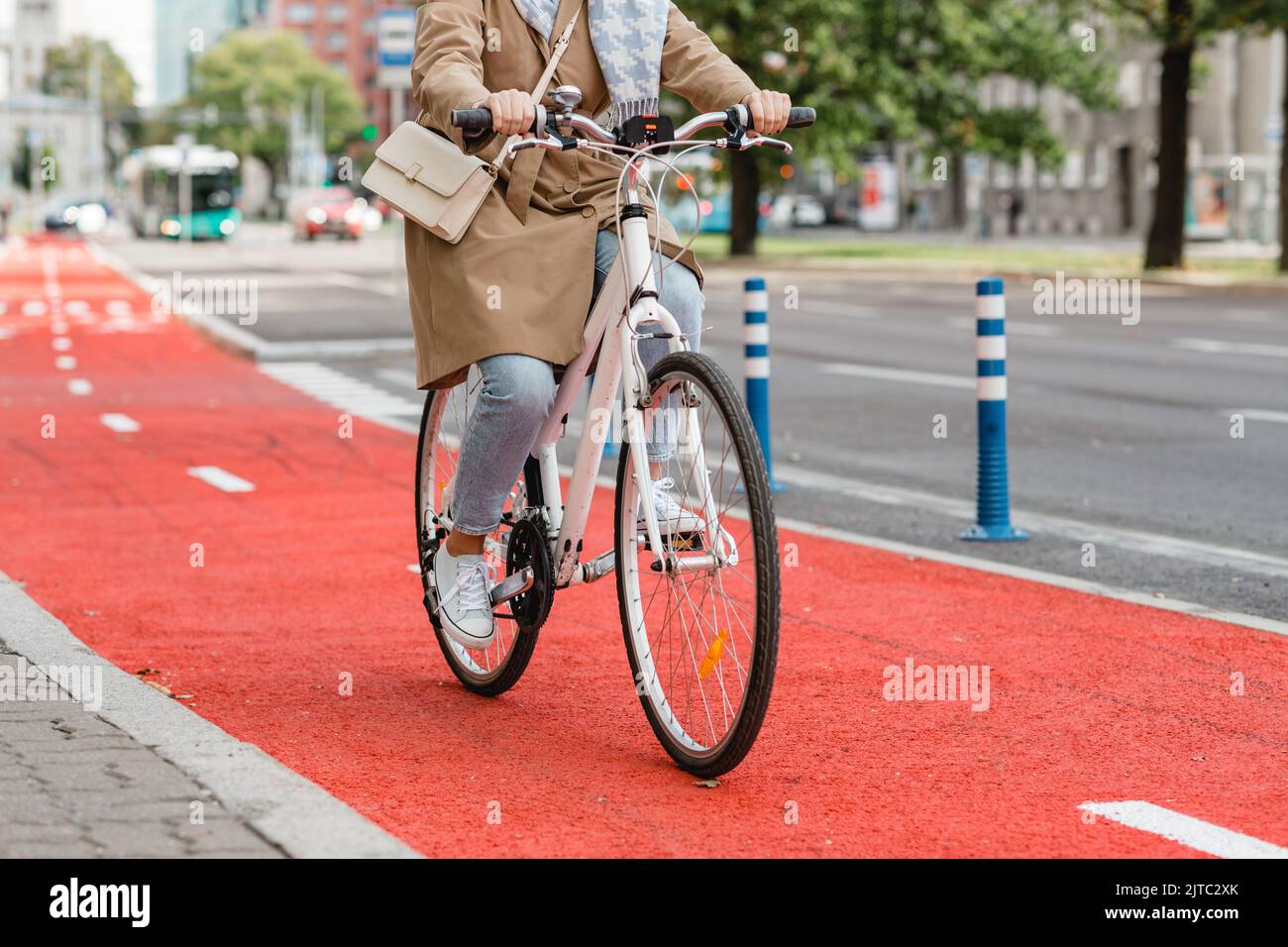 Woman riding red bike hi-res stock photography and images - Alamy