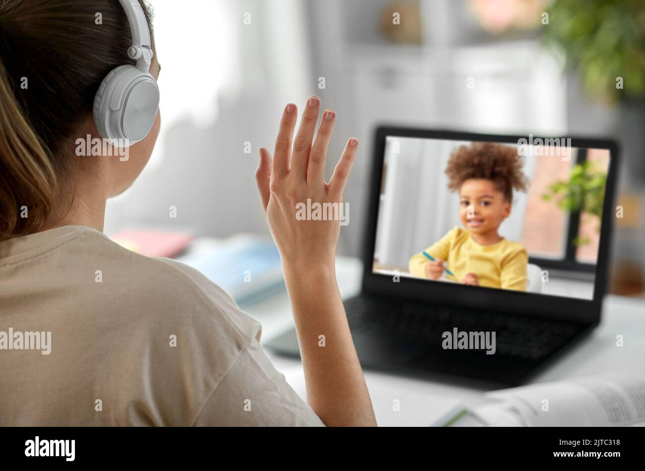 teacher with laptop having video call with girl Stock Photo - Alamy