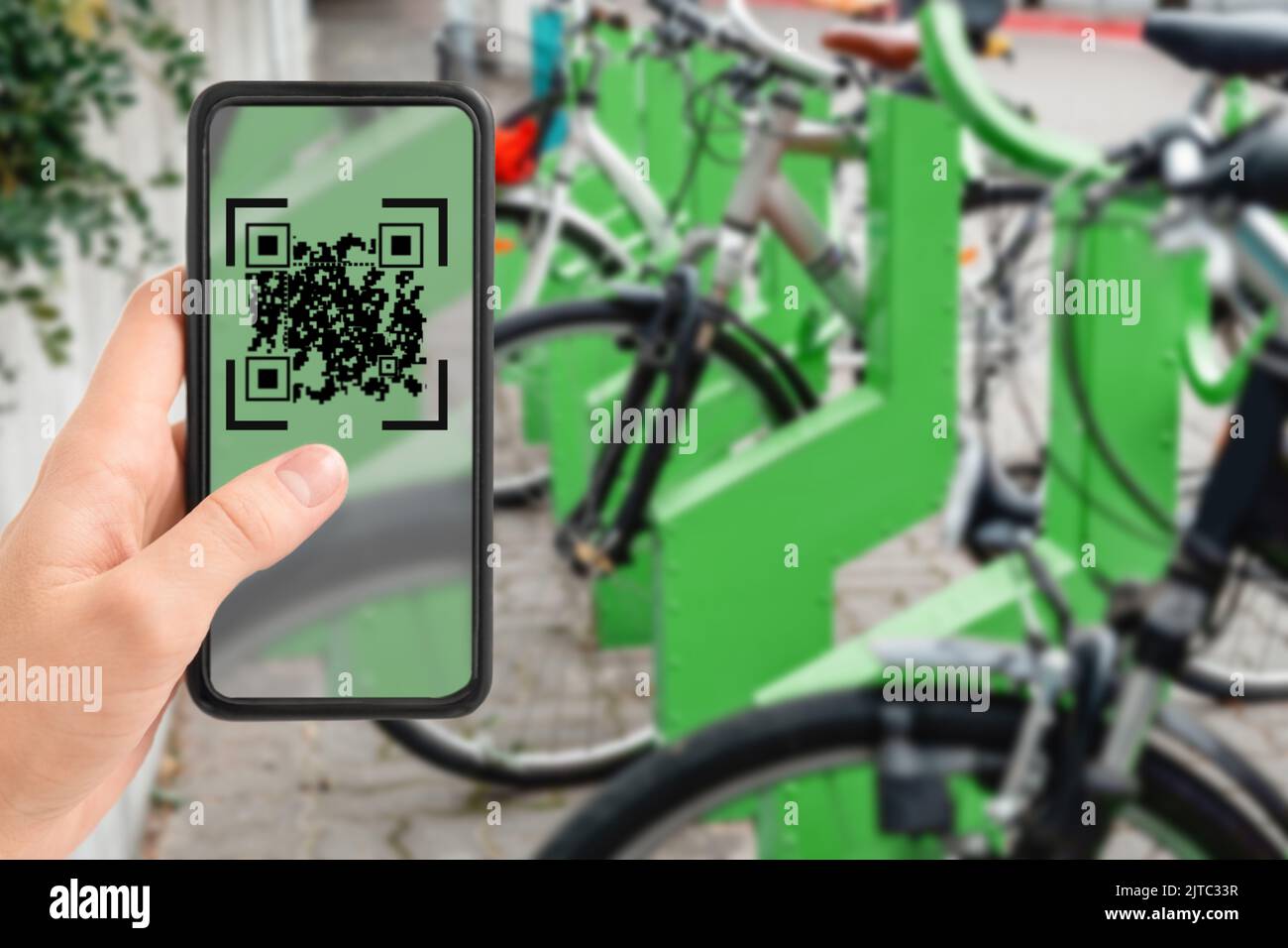 qr code on phone at electric bike charging station Stock Photo - Alamy