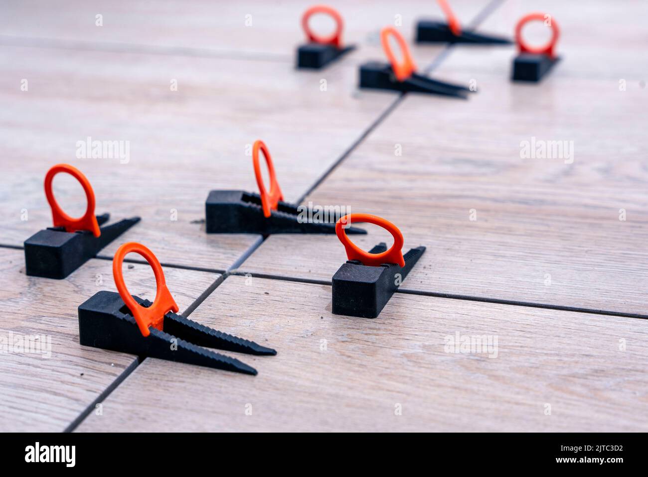 close-up of the tile alignment system holding tile in given position ...