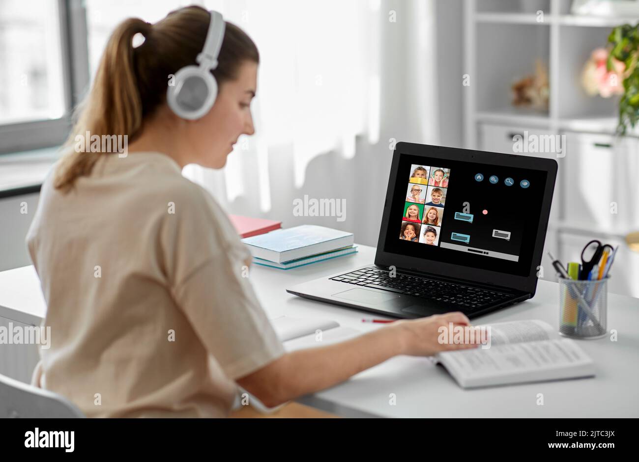 female teacher with laptop having online class Stock Photo - Alamy
