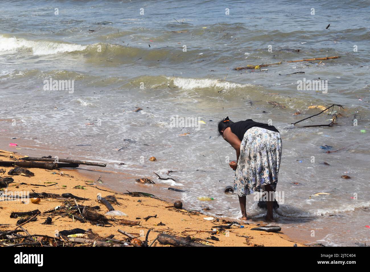 People collecting Wood and plastic wastage which has washed ashore due ...