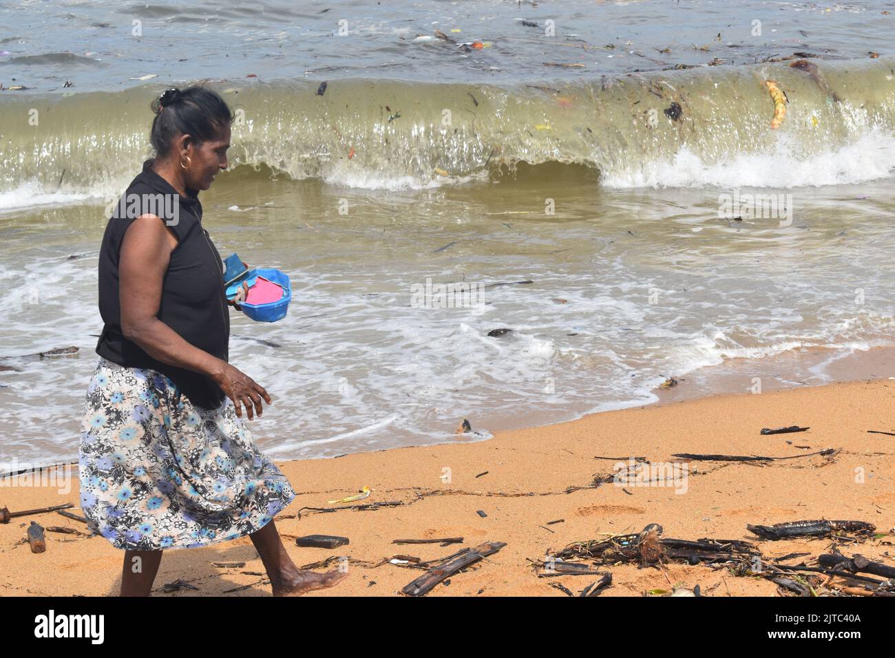 People collecting Wood and plastic wastage which has washed ashore due ...
