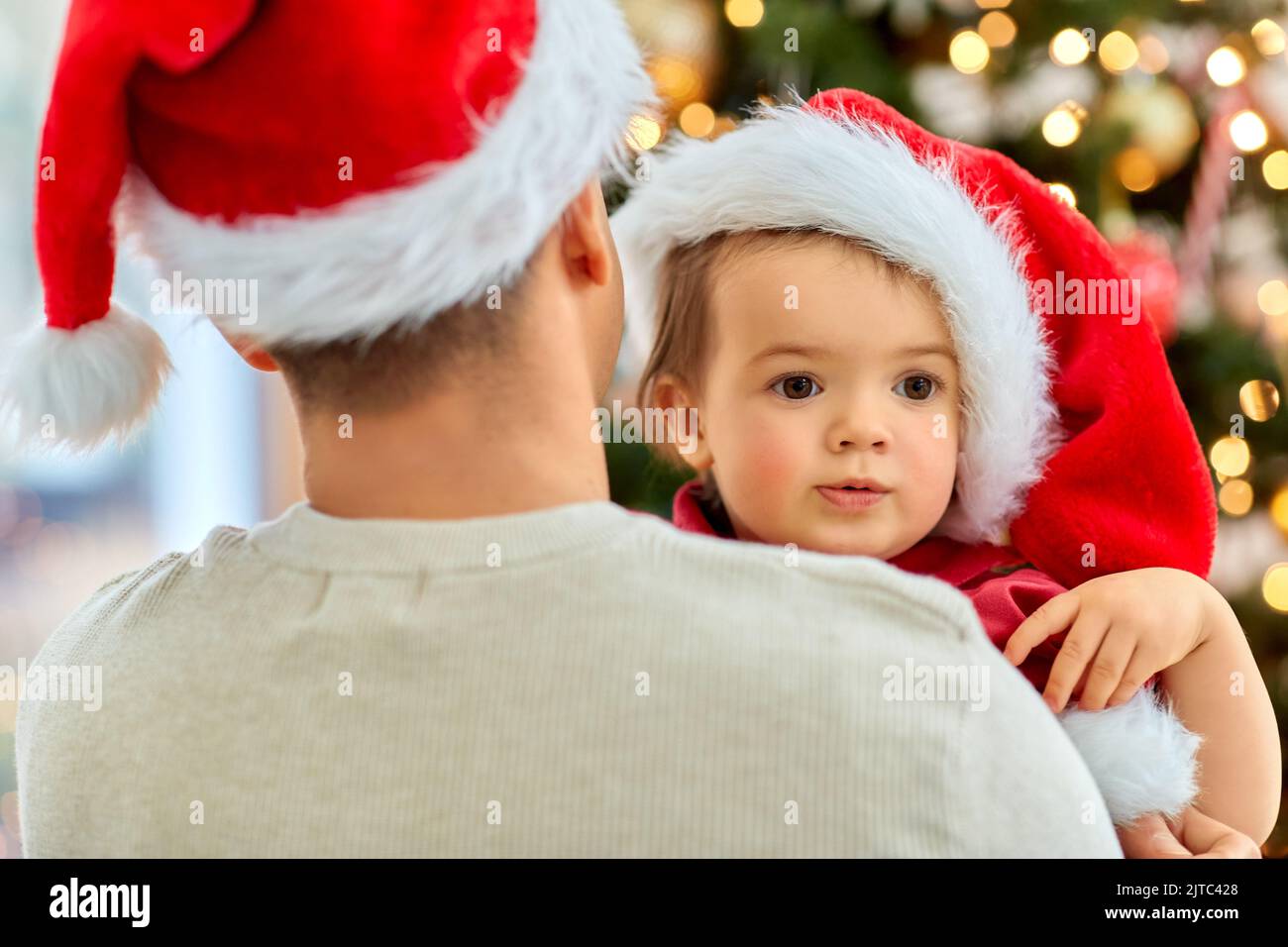 happy father and baby girl over christmas tree Stock Photo - Alamy