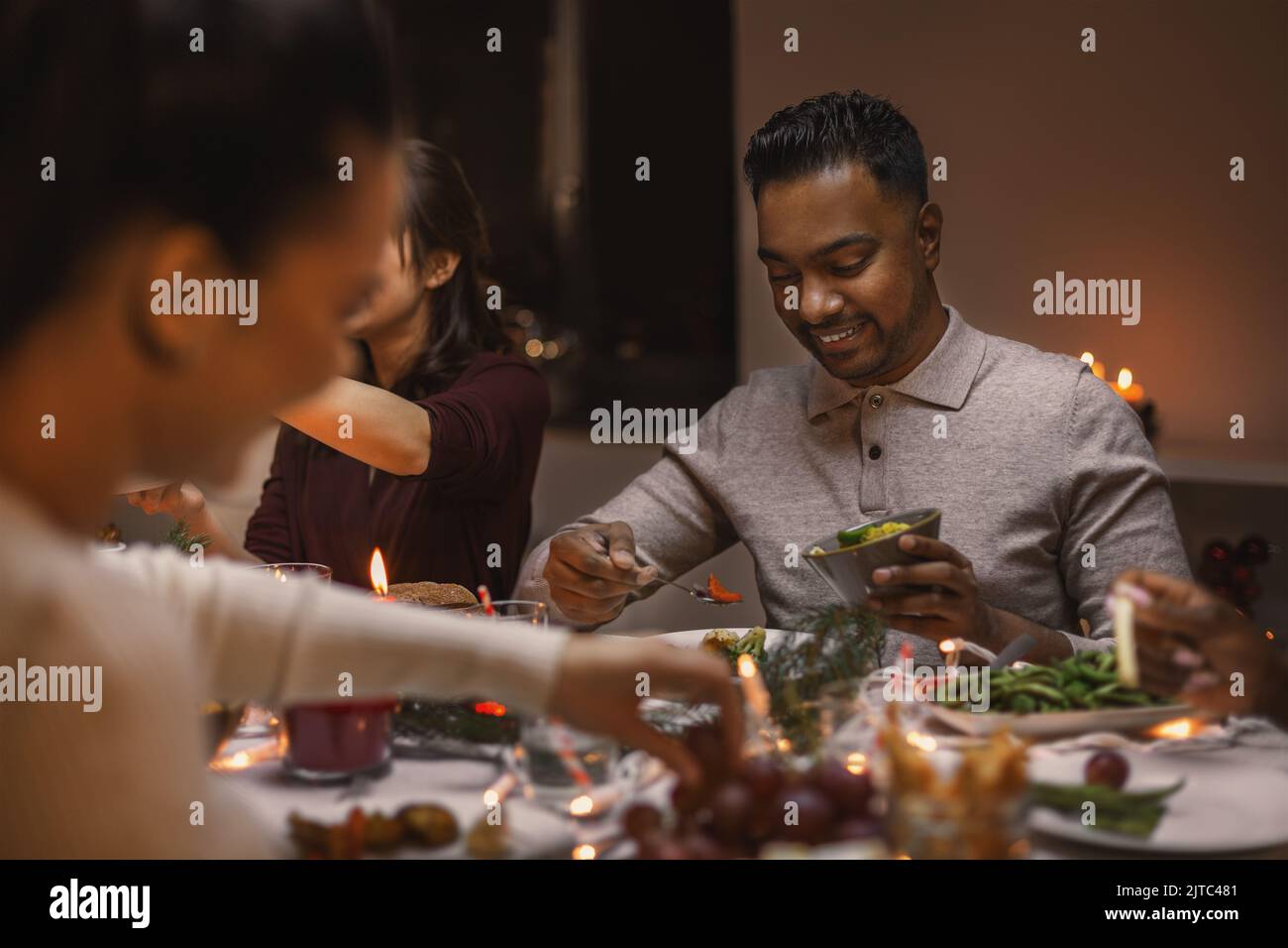 happy friends having christmas dinner at home Stock Photo - Alamy