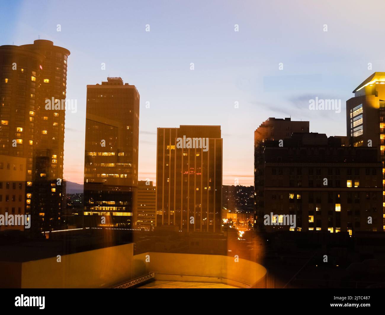 Seattle urban skyline at dusk with building windows and lights under ...