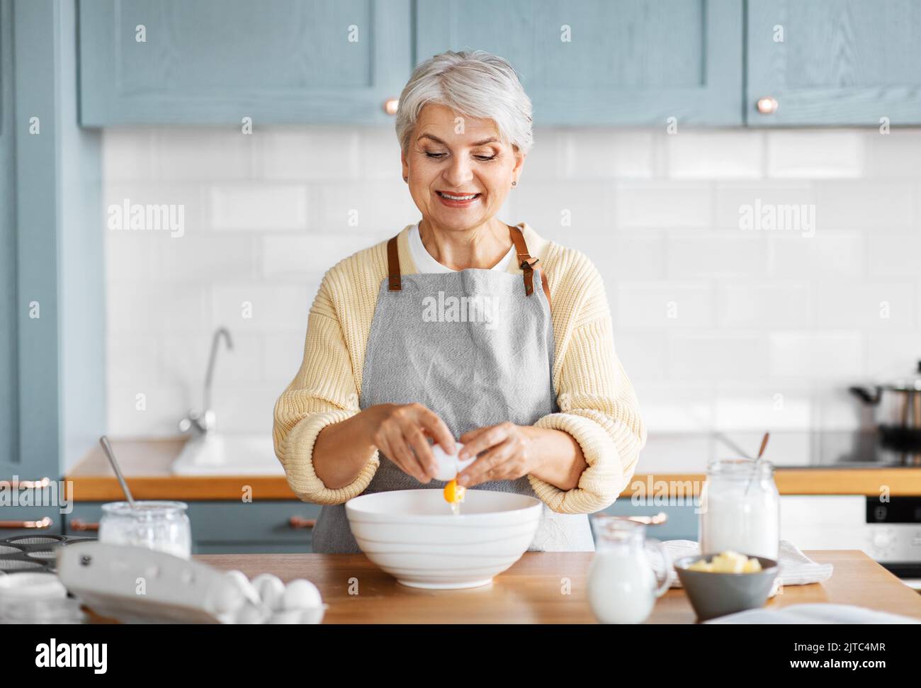 happy woman cooking food on kitchen at home Stock Photo - Alamy