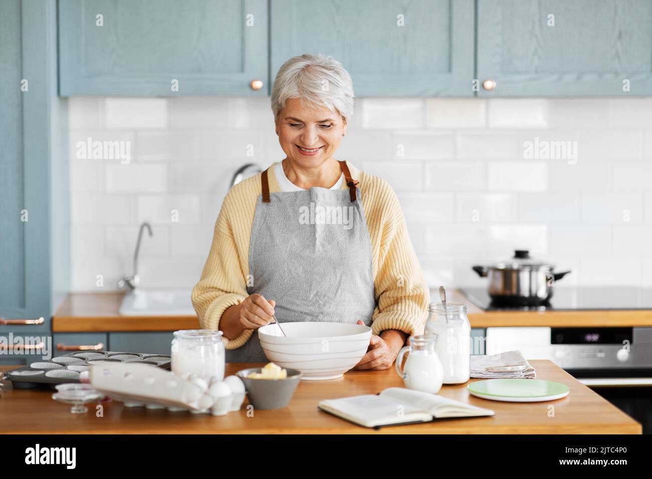 happy woman cooking food on kitchen at home Stock Photo - Alamy