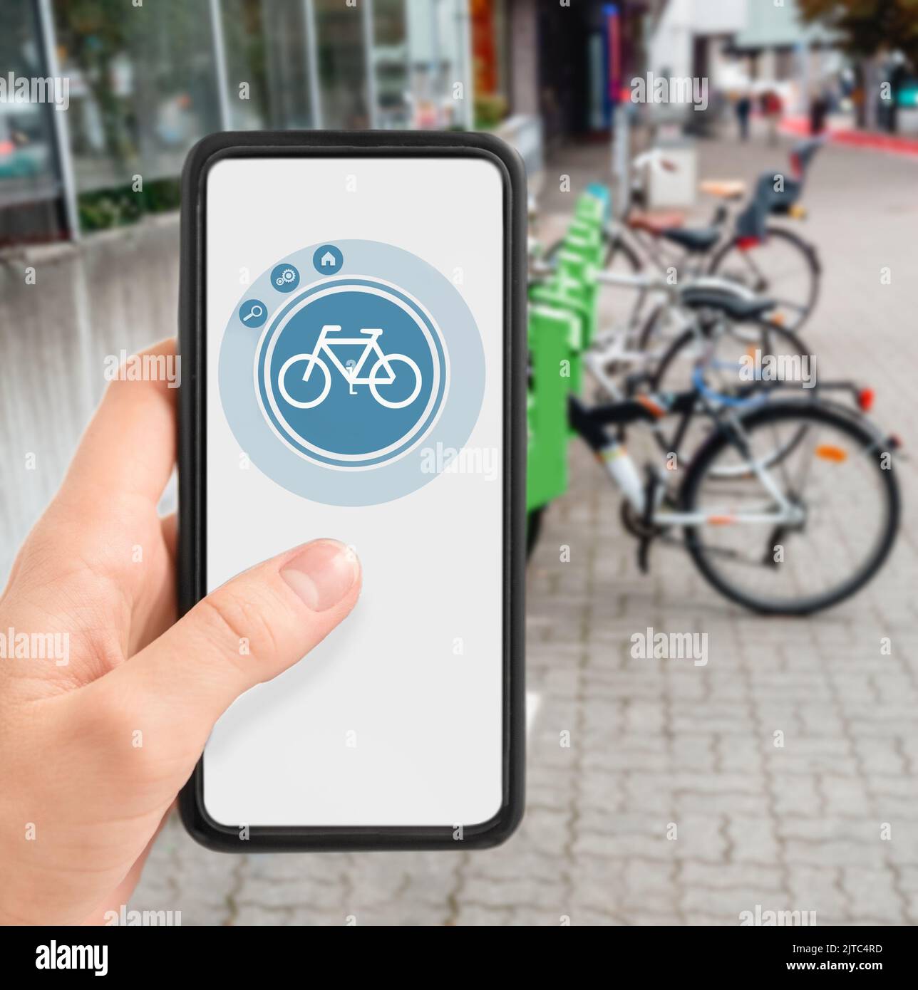 hand with phone at electric bike charging station Stock Photo - Alamy