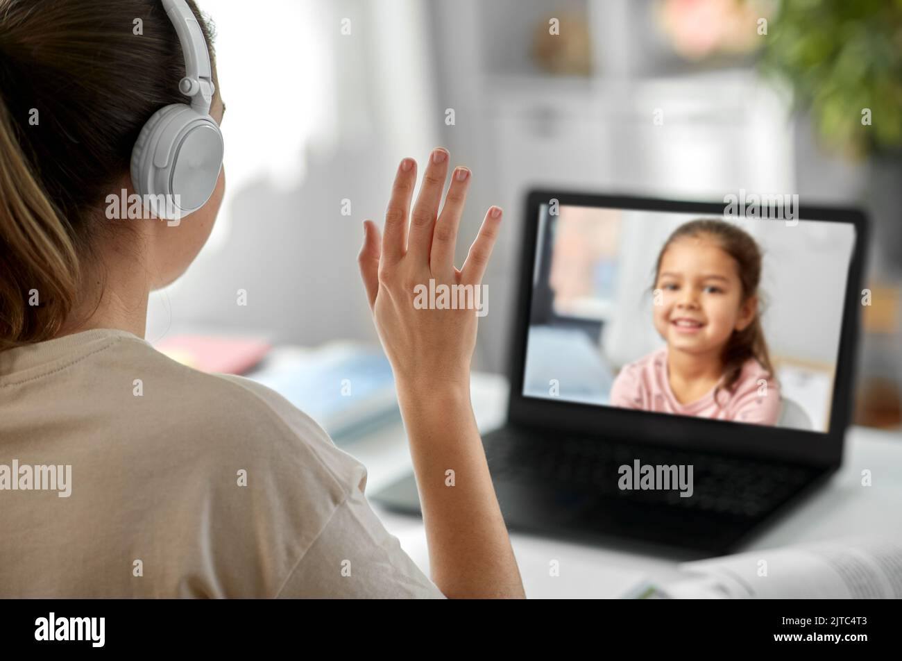 teacher with laptop having video call with girl Stock Photo - Alamy