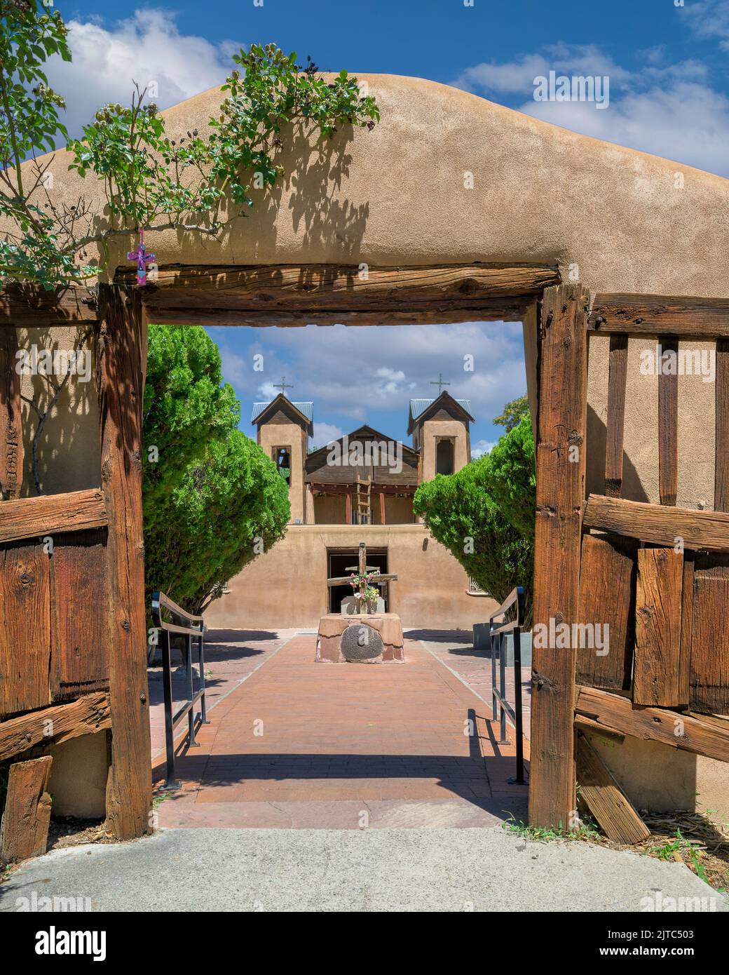 Entrance under adobe arch to historic Sanctuario de Chimayo Catholic ...
