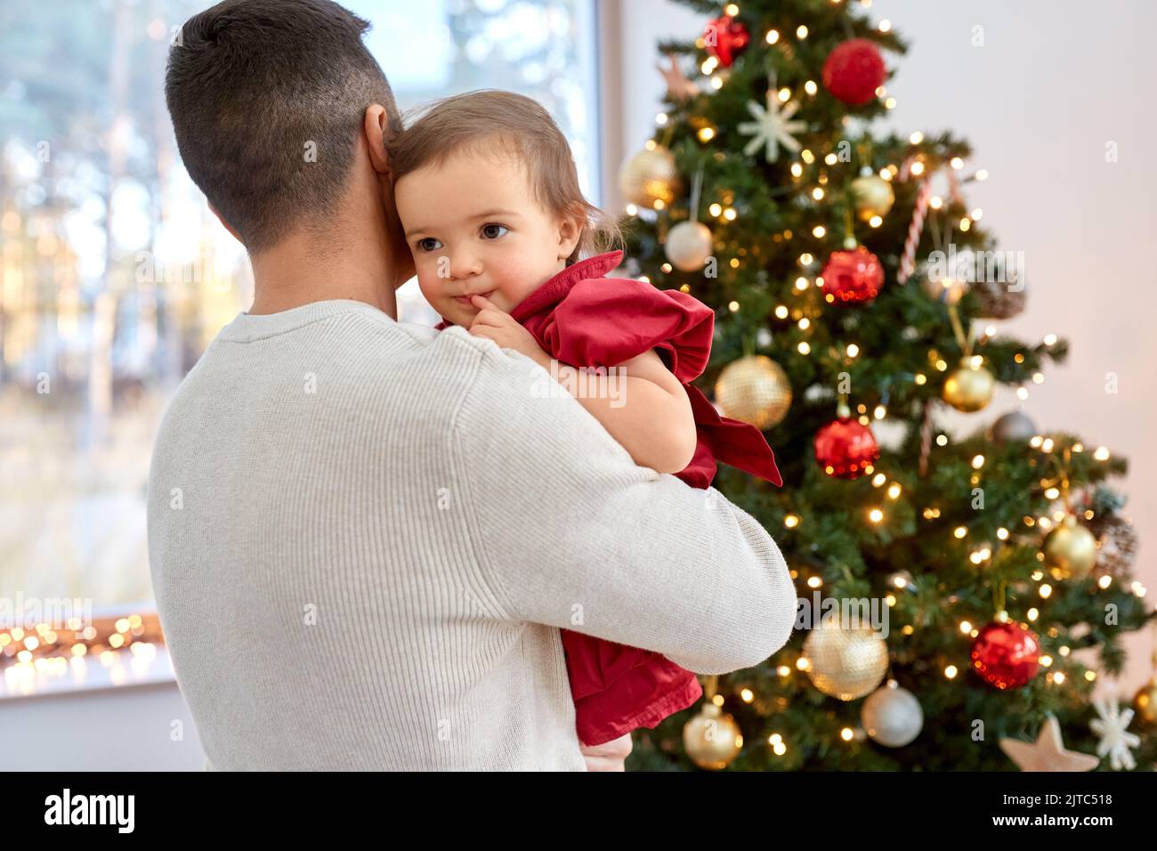 happy father and baby girl over christmas tree Stock Photo - Alamy